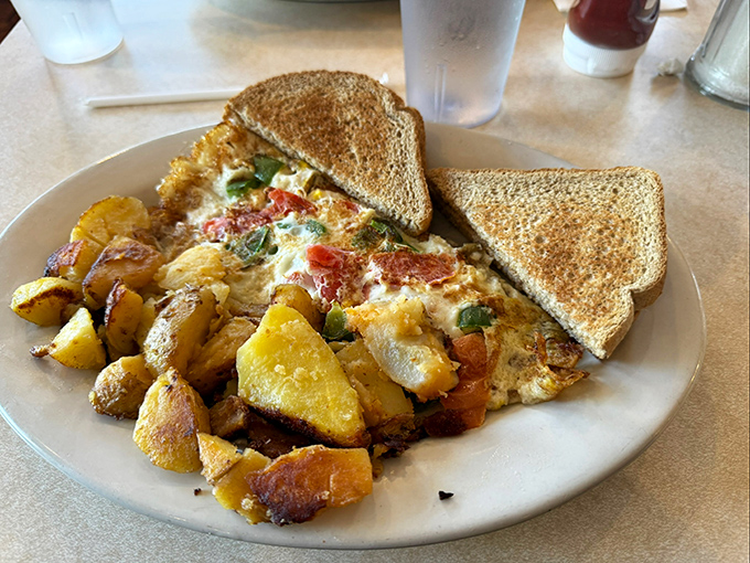 An omelet bursting with fresh vegetables alongside perfectly seasoned home fries. When vegetables taste this good, even committed carnivores won't complain.