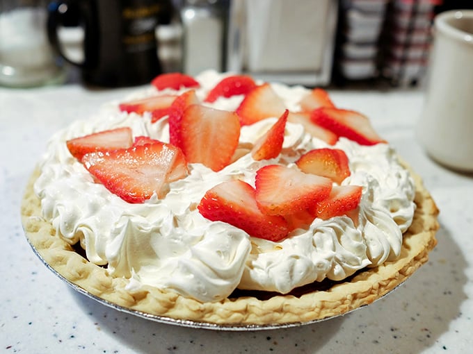 This isn't just strawberry pie&mdash;it's summer captured in a perfect circle, topped with clouds of whipped cream that make every forkful a celebration.