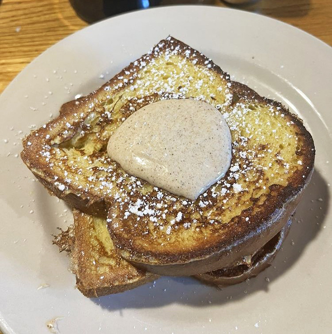 French toast that looks like it graduated from culinary school with honors, complete with what appears to be a dollop of cinnamon-spiced heaven.