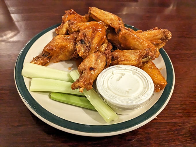 Wings that don't need a sports bar to shine. Crispy, saucy, with celery standing by like a loyal sidekick. 