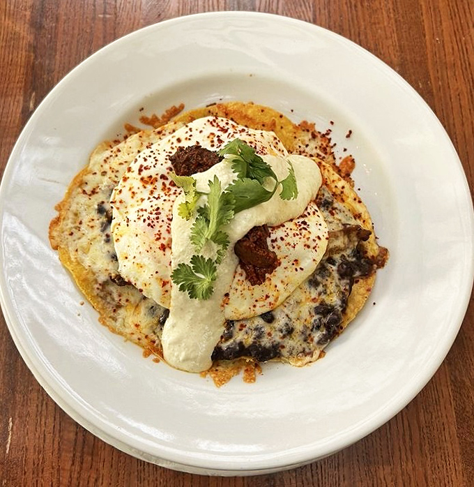 These huevos rancheros aren't just breakfast—they're a fiesta on a plate, complete with a cilantro crown.