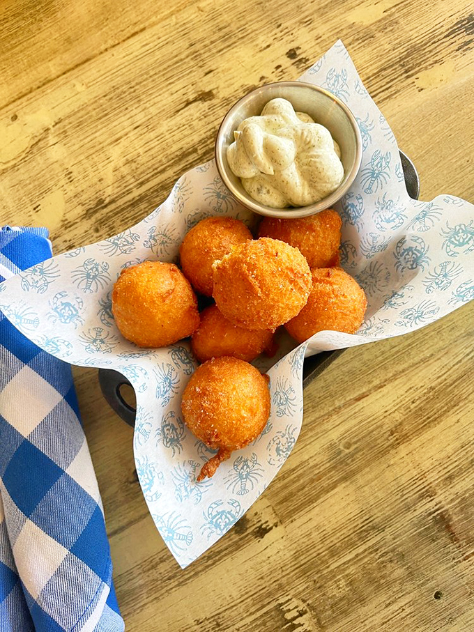 These golden hush puppies aren't just fried cornmeal &ndash; they're little spheres of Southern comfort that somehow taste like childhood memories.