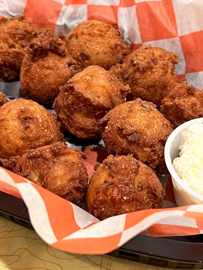 Hush puppies so perfectly golden they belong in Fort Knox, with a crispy exterior giving way to a tender cornmeal center.