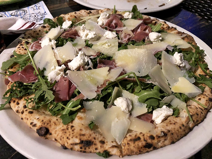 When prosciutto, arugula, and shaved parmesan meet a perfectly blistered crust, it's not just lunch—it's an Italian love affair on a plate.