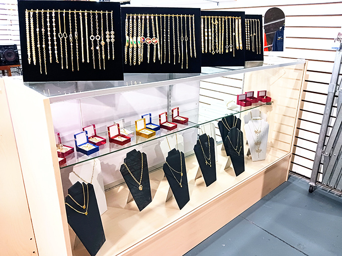 Gold gleams under fluorescent lights as necklaces hang like treasures in a modern-day pirate's cove. X marks the spot for bling hunters.