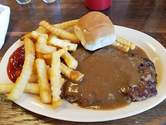 Hamburger steak swimming in gravy with a side of fries&mdash;comfort food that hugs your soul and whispers, "Everything's gonna be alright."