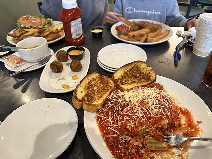 A family gathering around plates of pasta and garlic bread&mdash;this is the universal language of "nobody's leaving hungry tonight."