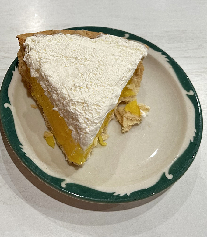 Lemon meringue pie with clouds of white fluff so high they need FAA clearance, sitting atop sunshine-yellow filling that strikes the perfect sweet-tart balance.