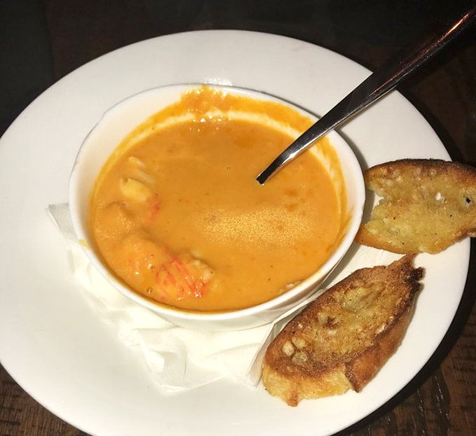 Lobster bisque that's the perfect shade of sunset orange, with actual pieces of lobster playing hide and seek in that velvety broth. 