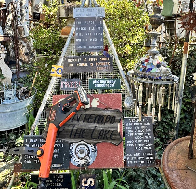 This whimsical outdoor art installation, layered with quotes, signs, and found objects, turns everyday clutter into a patchwork of creativity that invites you to stop, look, and snap a photo.