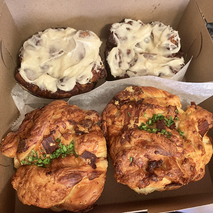 Savory meets sweet in this box of baked treasures. The cinnamon rolls look like they're wearing cream cheese sweaters for the world's most delicious fashion show.