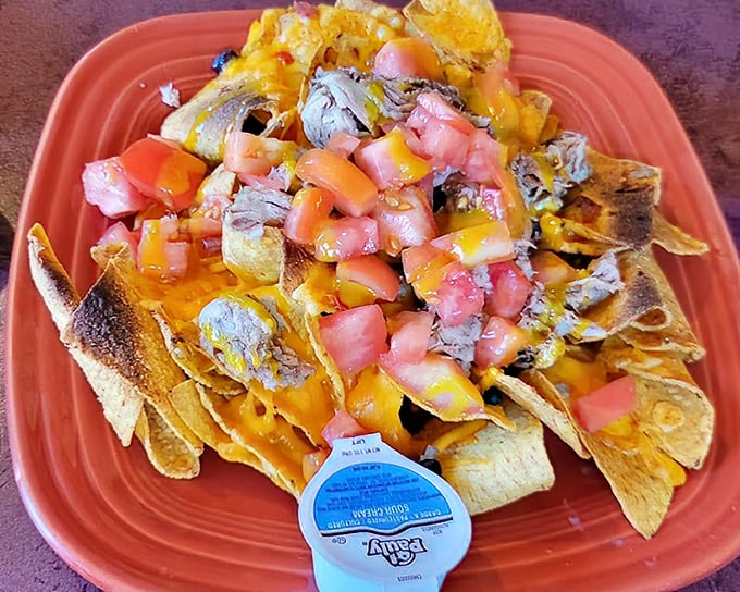 Nachos that solve the eternal problem of topping distribution&mdash;every chip gets its fair share of melty cheese, brisket, and fresh tomatoes.