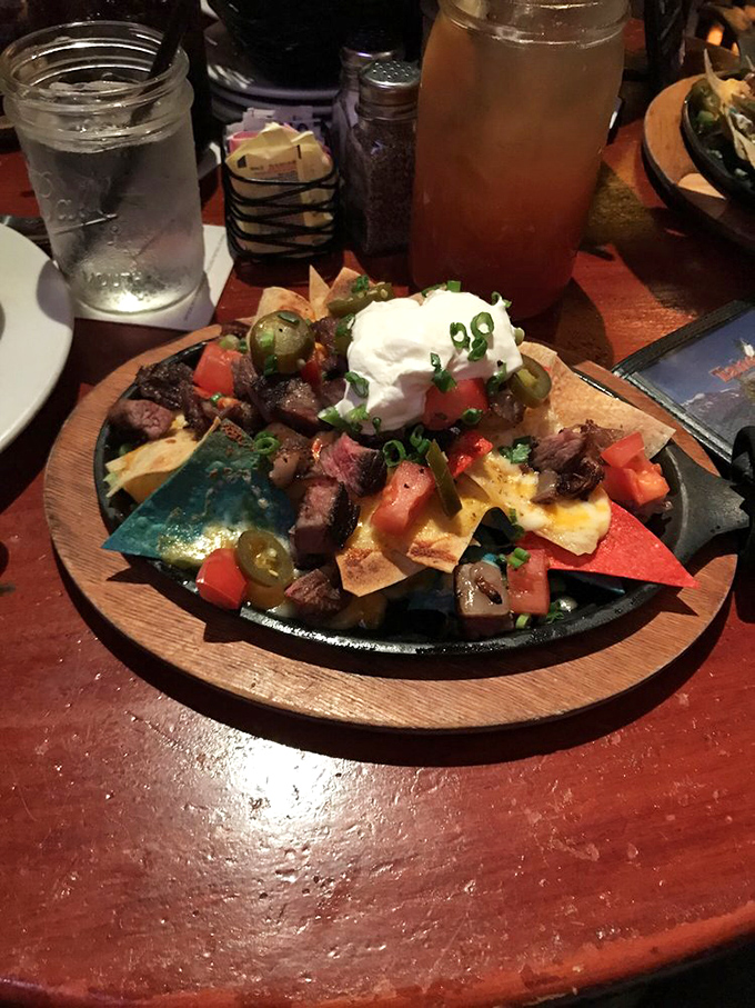 These nachos aren't messing around&mdash;they're what happens when steak meets chips in a delicious summit meeting. The sour cream dollop on top is like the chef's signature on a masterpiece.