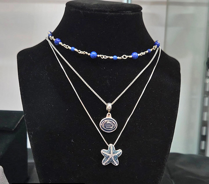 Delicate necklaces featuring Penn State logos and starfish pendants&mdash;proof that second-hand jewelry still carries first-rate charm.