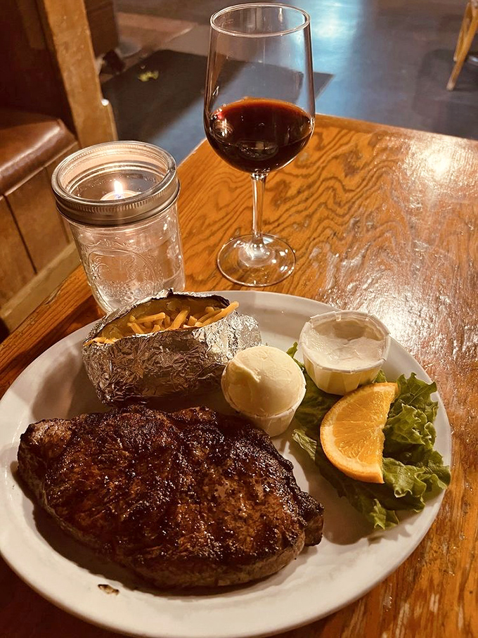 A New York strip served with all the fixings and none of the pretension. That baked potato in foil is the security blanket every great steak deserves.