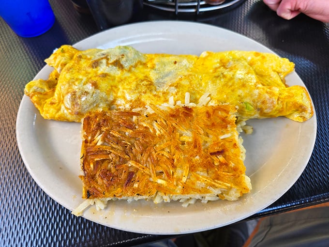 An omelet that's fluffy enough to double as a pillow, paired with hash browns that have achieved the perfect crisp-to-tender ratio. Breakfast engineering at its finest.