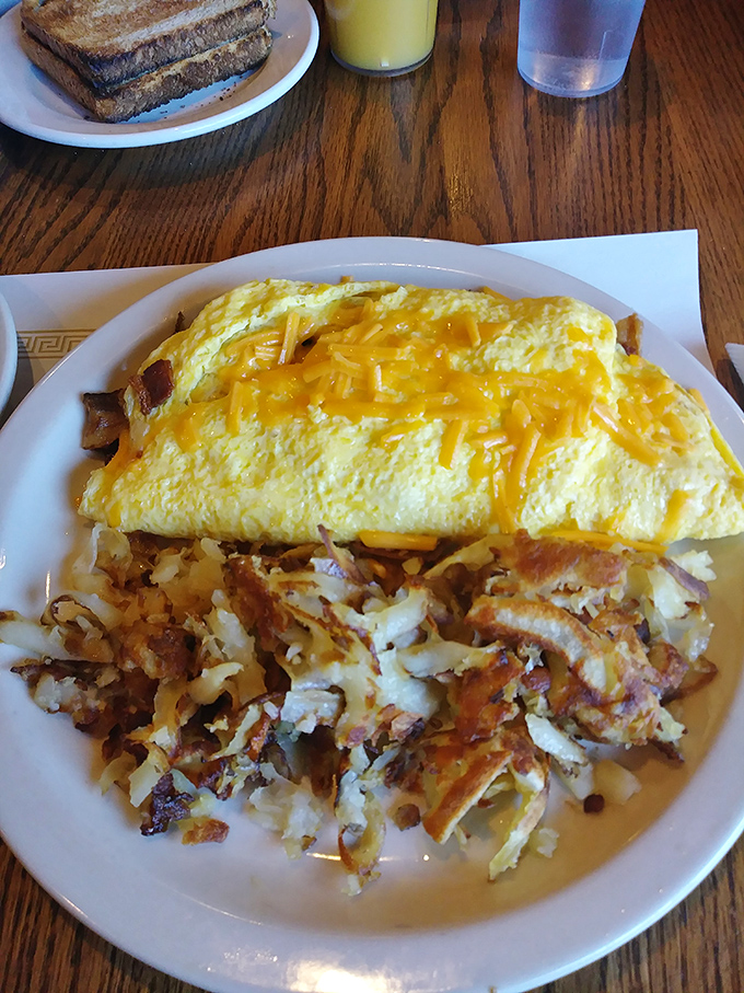 An omelet that's actually folded around its fillings, not just ingredients thrown at eggs. Those hash browns deserve their own fan club.
