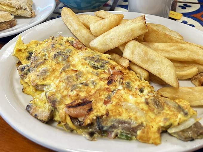 This isn't just an omelet&mdash;it's a fluffy yellow canvas painted with savory ingredients and paired with potato perfection.