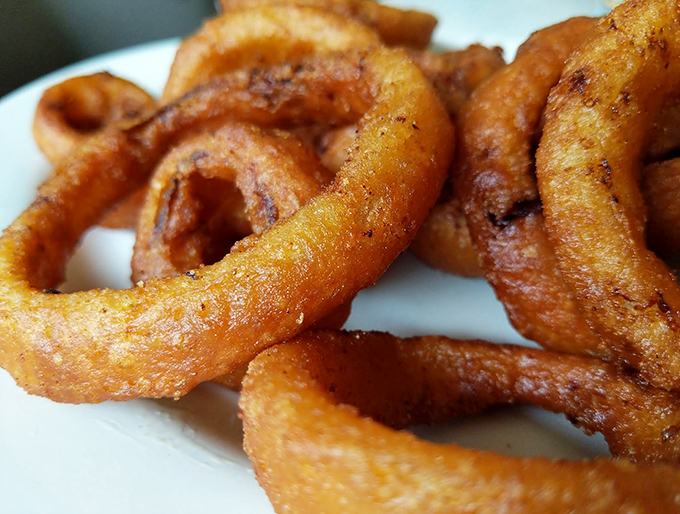 Onion rings should always look like this: golden halos of crispy perfection that make you temporarily forget vegetables are supposed to be healthy.