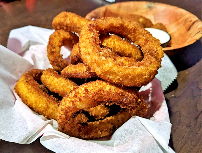 These aren't just onion rings; they're golden halos of crispy perfection that make you question why anyone would ever eat onions any other way.