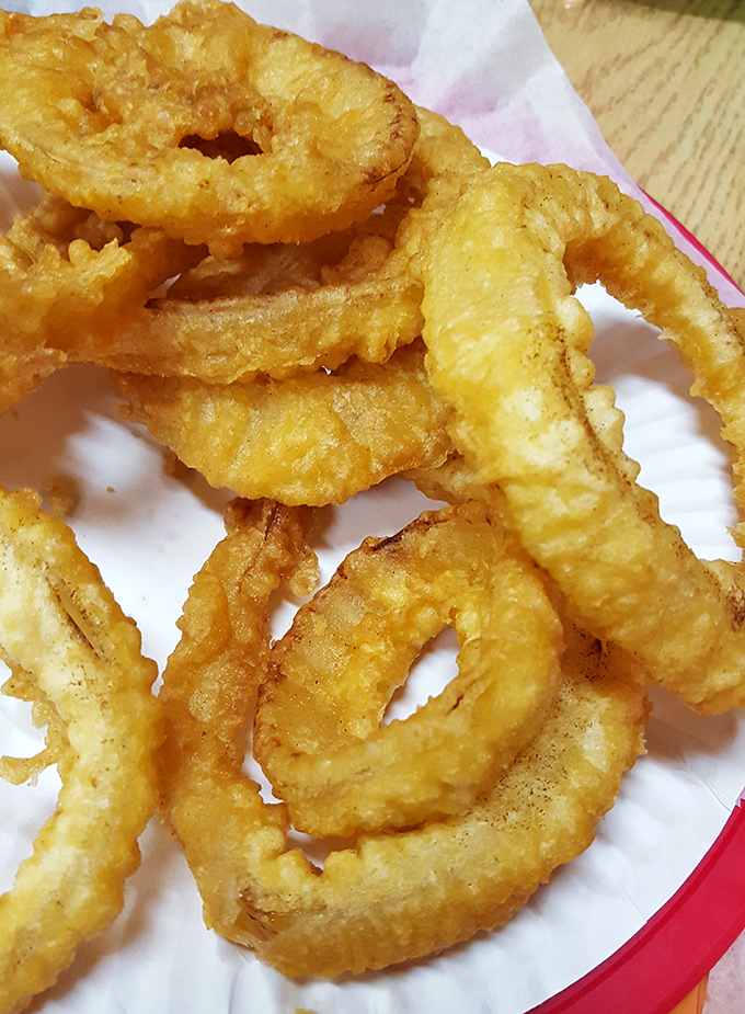 Onion rings so perfectly golden they deserve their own Olympic medals. Each bite delivers that satisfying crunch that makes you close your eyes in appreciation.