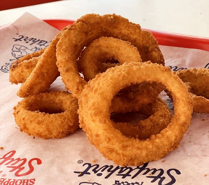 Golden rings of happiness stacked like delicious jewelry. These onion rings aren't just a side&mdash;they're the supporting actors that steal the show.