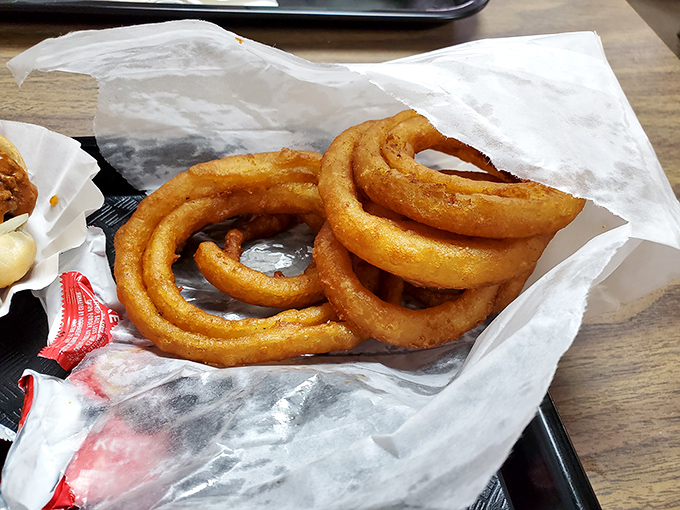 These onion rings aren't just side dishes; they're golden halos of perfection that make you question why you ever settled for less.