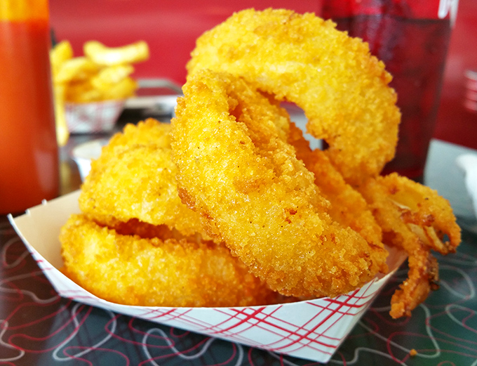 Onion rings like gold medals for your taste buds &ndash; crispy, golden halos that shatter satisfyingly between your teeth, revealing sweet onion treasure inside.