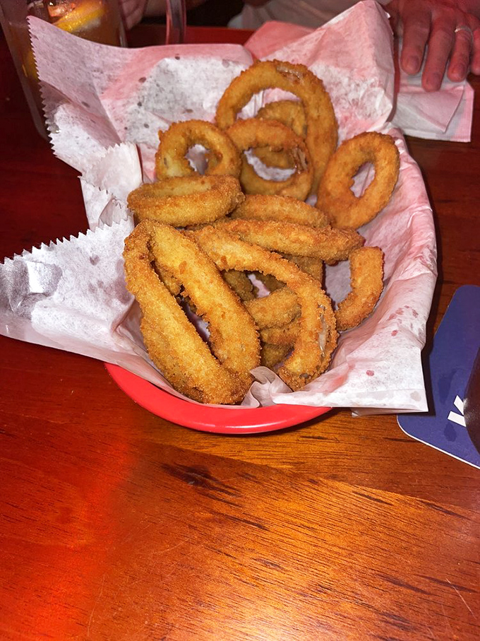 Golden halos of deep-fried perfection. These onion rings aren't just a side dish—they're the supporting actors that sometimes steal the show.