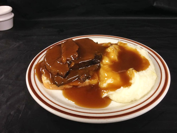 Open-faced roast beef that doesn't hide behind pretension. The gravy cascading over those mashed potatoes is performing a delicious magic trick before your eyes.