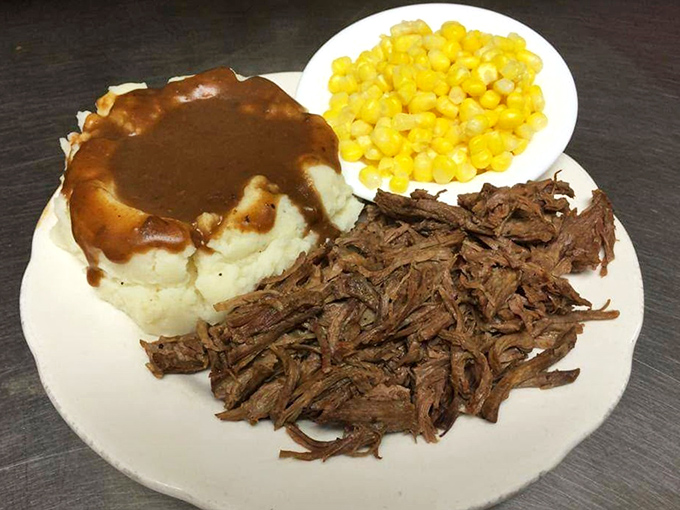 
Mashed potatoes drowning happily in gravy, tender pot roast, and sweet corn&mdash;the holy trinity of Midwestern comfort on a single plate. 