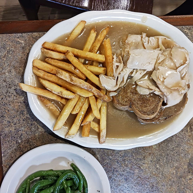Thanksgiving on a plate, any day of the year&mdash;tender turkey and savory gravy atop bread with green beans on the side, no family drama required.