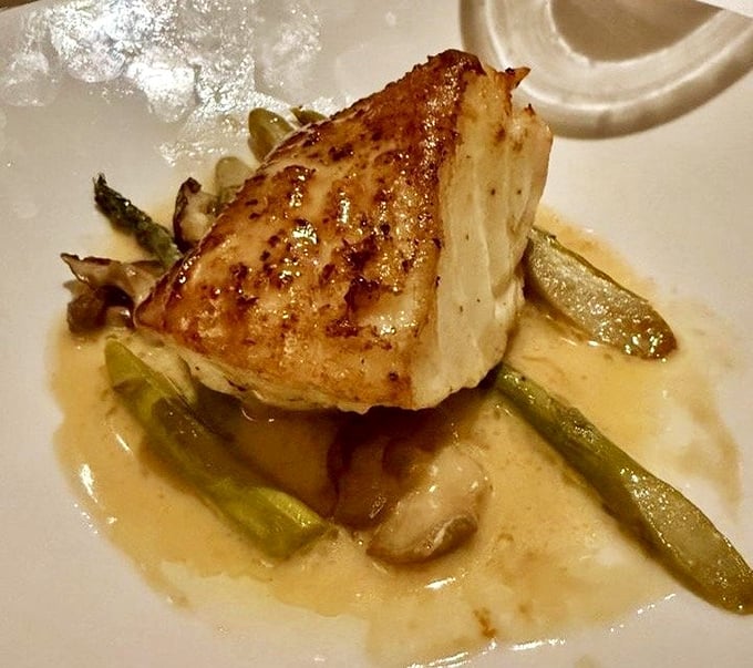 Perfectly seared fish perched atop asparagus islands in a butter sea. The kind of dish that makes you close your eyes on first bite.