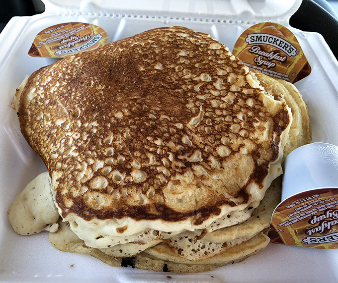 Pancakes so perfectly golden they belong in the Breakfast Hall of Fame, with those little packets of syrup standing by like eager understudies.