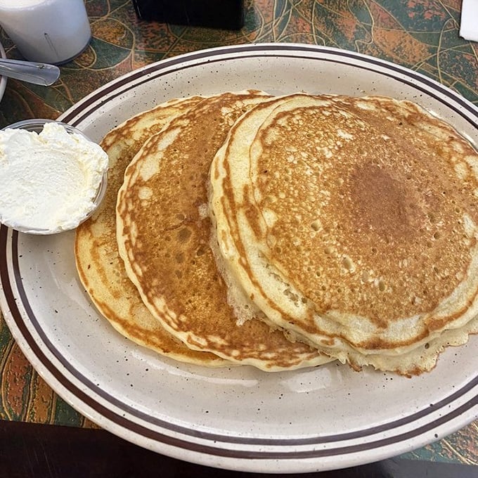 Pancakes so perfectly golden they could make IHOP executives weep with envy. The butter melts just watching you approach.