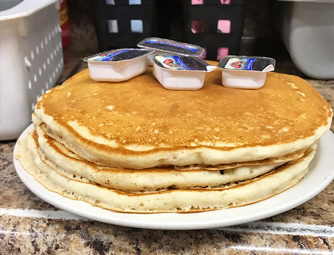 Pancakes stacked higher than my unread emails, with butter melting into every nook and cranny. Maple syrup sold separately, happiness included.