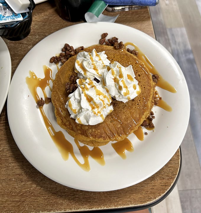 These pancakes don't just sit on the plate &ndash; they perform, topped with a cloud of whipped cream and caramel drizzle that makes maple syrup jealous.