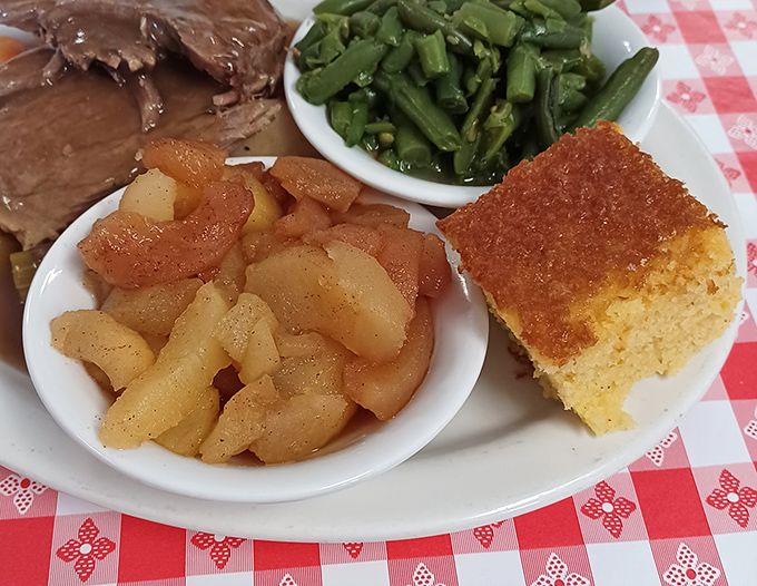 Southern hospitality on a plate: tender apples, cornbread, and green beans that taste like someone's grandmother is working the kitchen line.