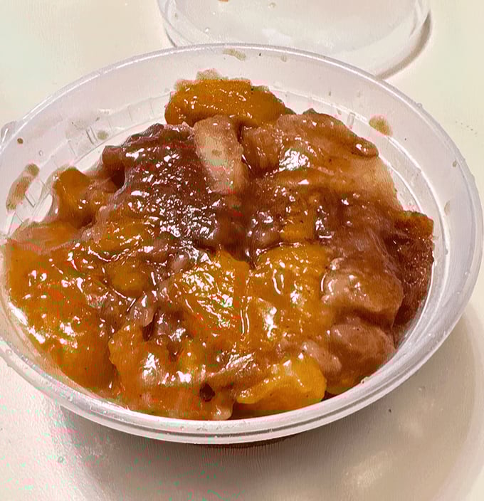 Peach cobbler that looks like summer sunshine captured in a container, ready to warm your heart completely.