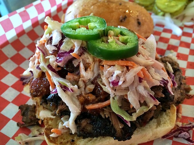The Pitmaster sandwich doesn't just satisfy hunger—it obliterates it. That slaw and jalapeño provide the perfect counterpoint to smoky meat.