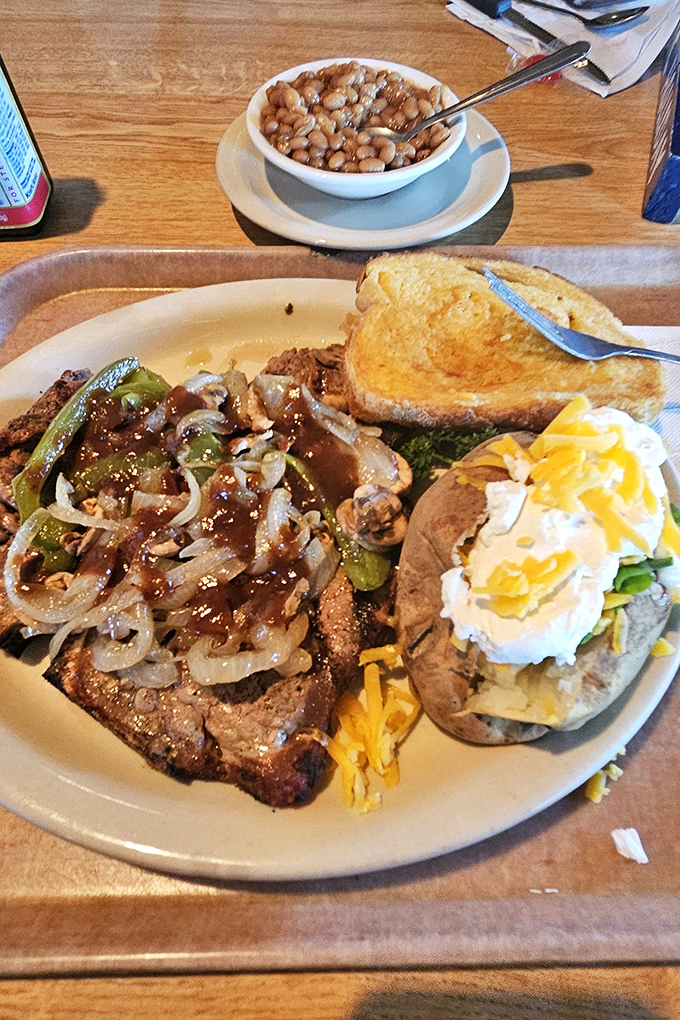 A classic plate featuring steak, baked potato loaded with cheese, and those magical pinto beans. Comfort food that speaks a universal language.