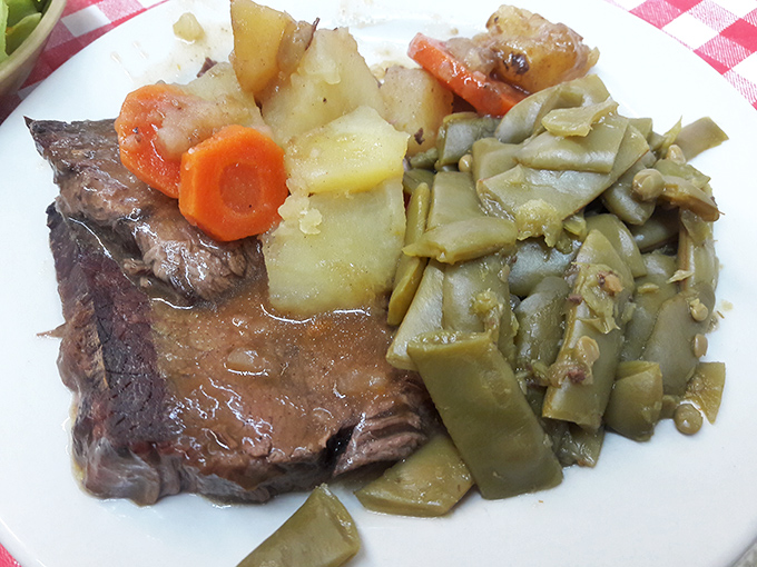 This pot roast has clearly been cooking since yesterday, surrounded by vegetables that gave their lives for a noble cause.