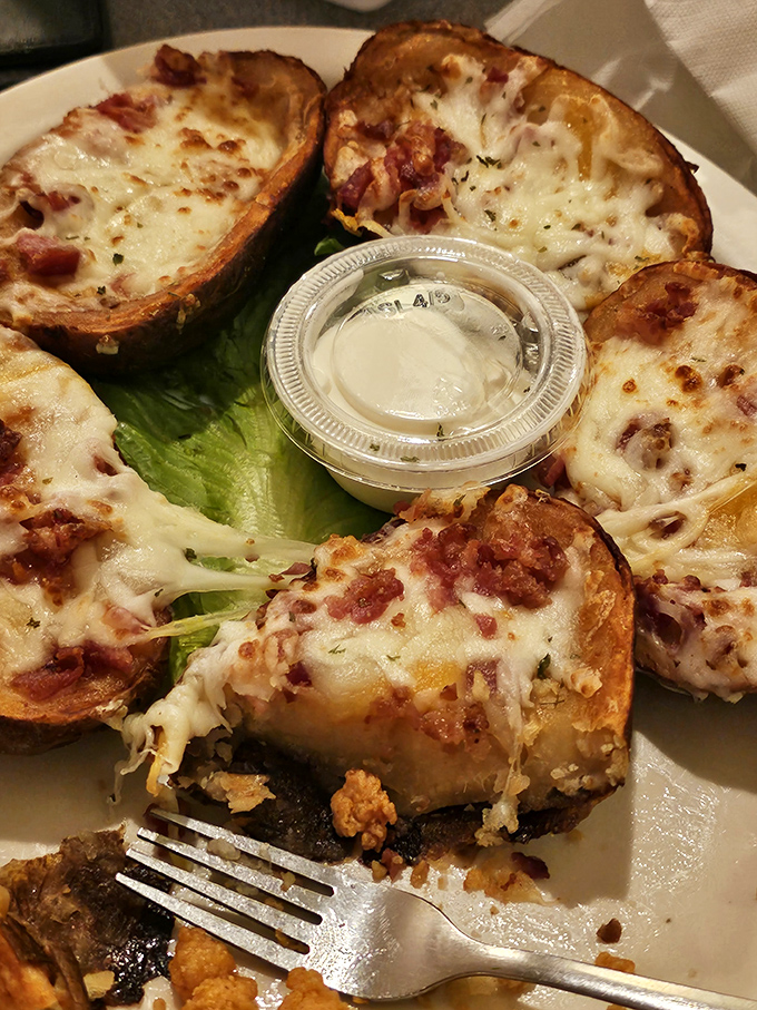 Potato skins loaded with melty cheese and bacon bits&mdash;proof that sometimes the boat needs to stay docked while you indulge in landlubber delights.