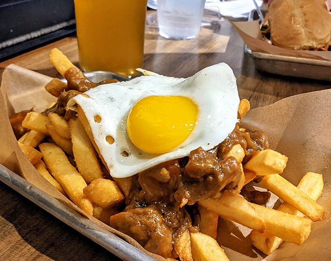 Fries living their best life, smothered in savory curry and crowned with a sunny-side-up egg that's just waiting for its Instagram moment.