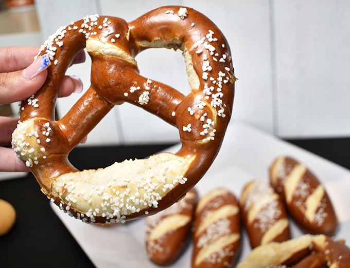 That pretzel isn't just twisted dough&mdash;it's German engineering at its finest. The salt crystals glisten like edible diamonds on a mahogany canvas.