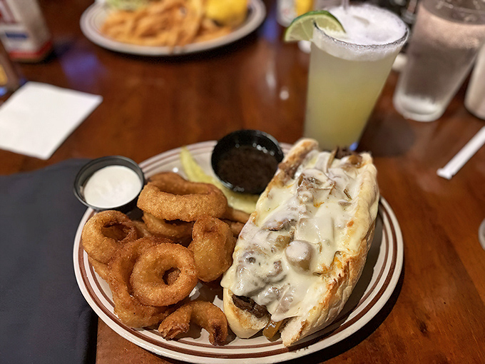 When a sandwich requires both hands and your full attention&mdash;tender prime rib nestled in bread with golden onion rings standing guard.