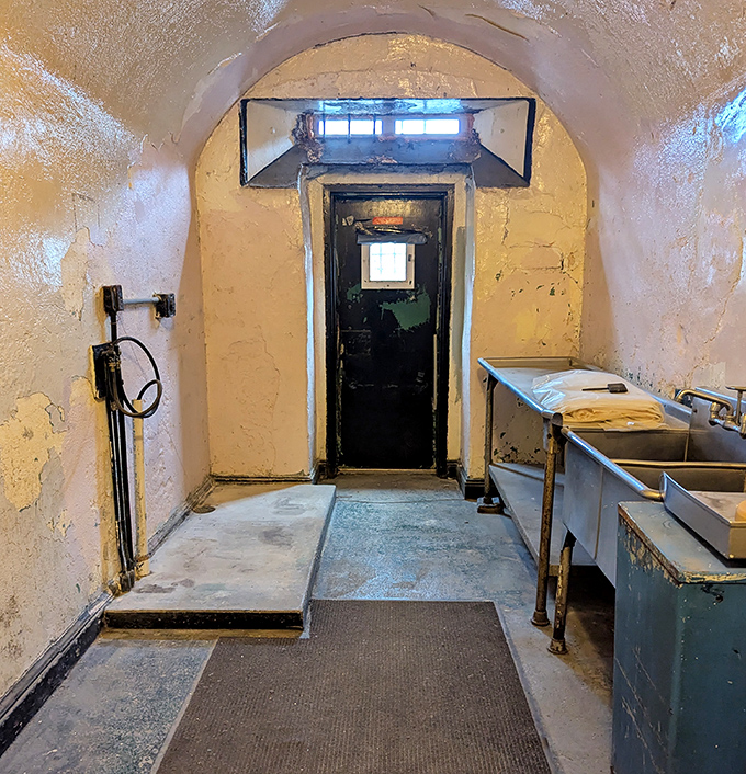 The institutional grit of this passageway whispers tales of countless footsteps, each one marking time in the most literal sense.