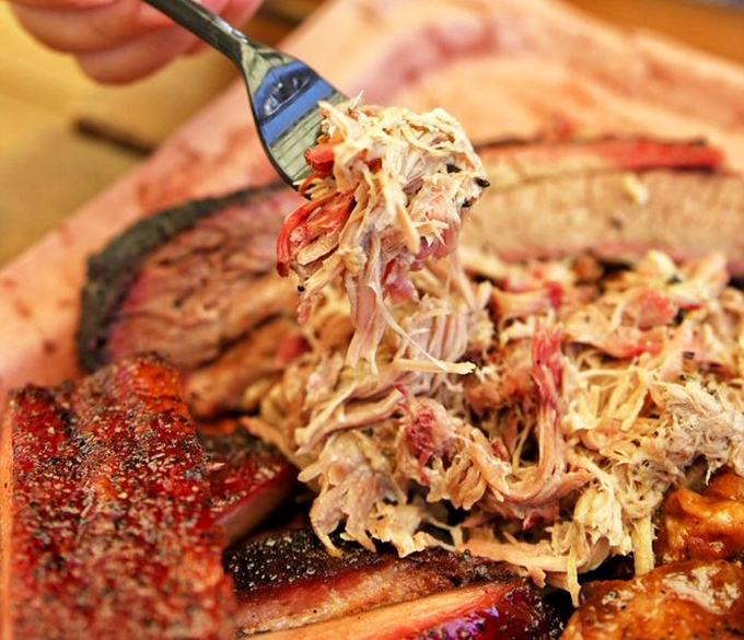 Pulled pork that doesn't need a swimming pool of sauce to impress. These tender strands with bits of bark mixed in are barbecue alchemy at its finest.