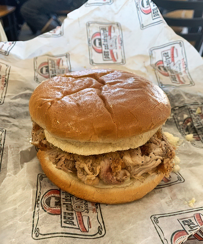 The humble sandwich that launched a thousand road trips. No fancy garnishes, just pure pork perfection on a soft bun.