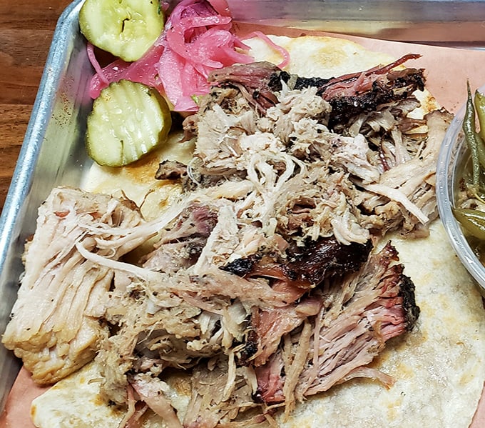 Pulled pork so tender it practically pulled itself. Those pickles and onions aren't garnish&mdash;they're essential supporting characters.